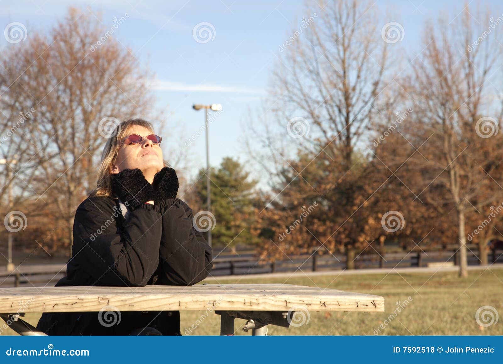 Woman Basking in Winter Sun Stock Photo - Image of happy, bench: 7592518