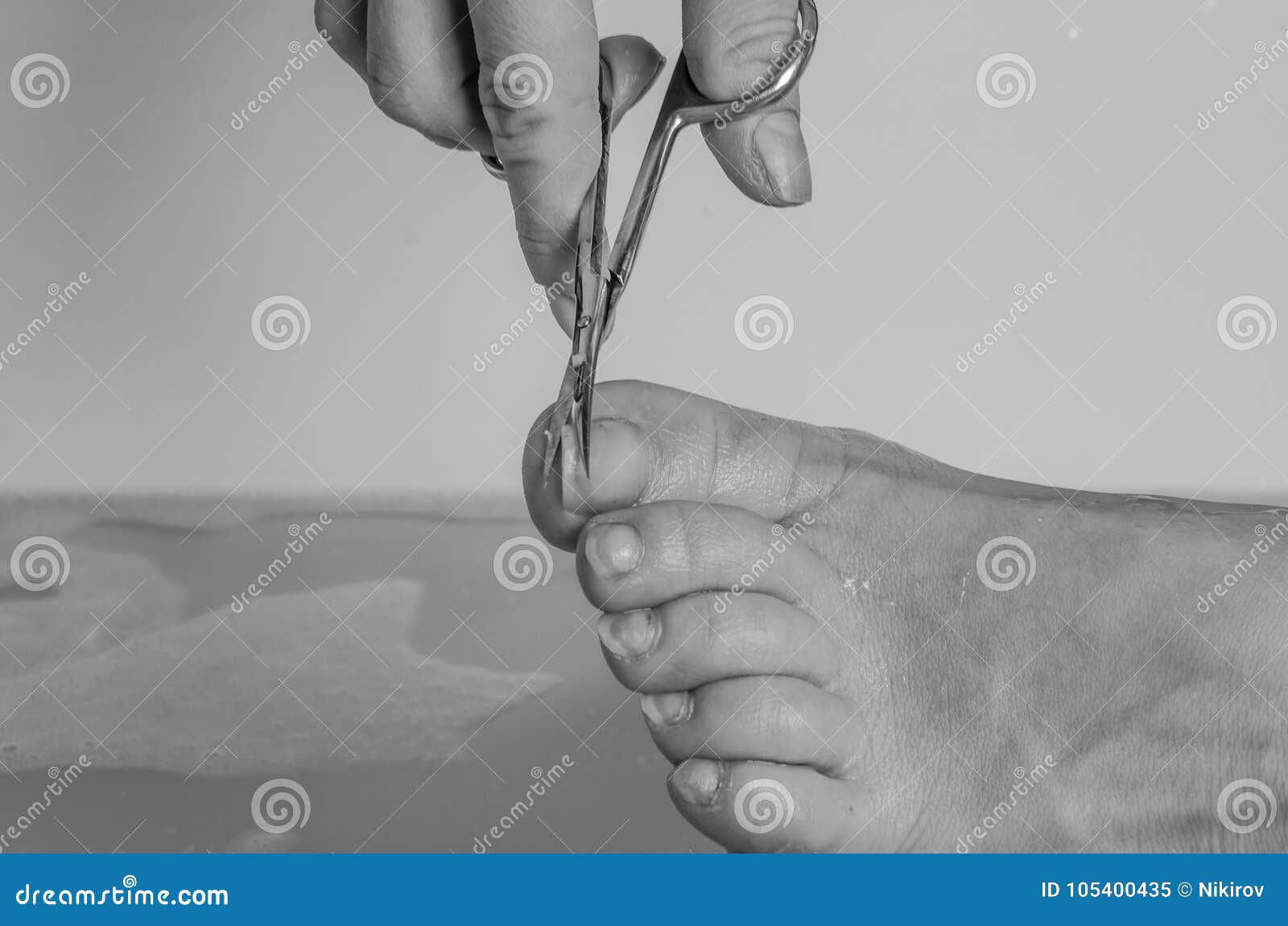 A Woman in the Bath Shears Her Nails, Doing a Manicure on Her Legs ...