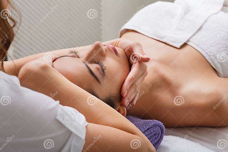 Woman Beautician Doctor Make Head Massage In Spa Wellness Center Stock