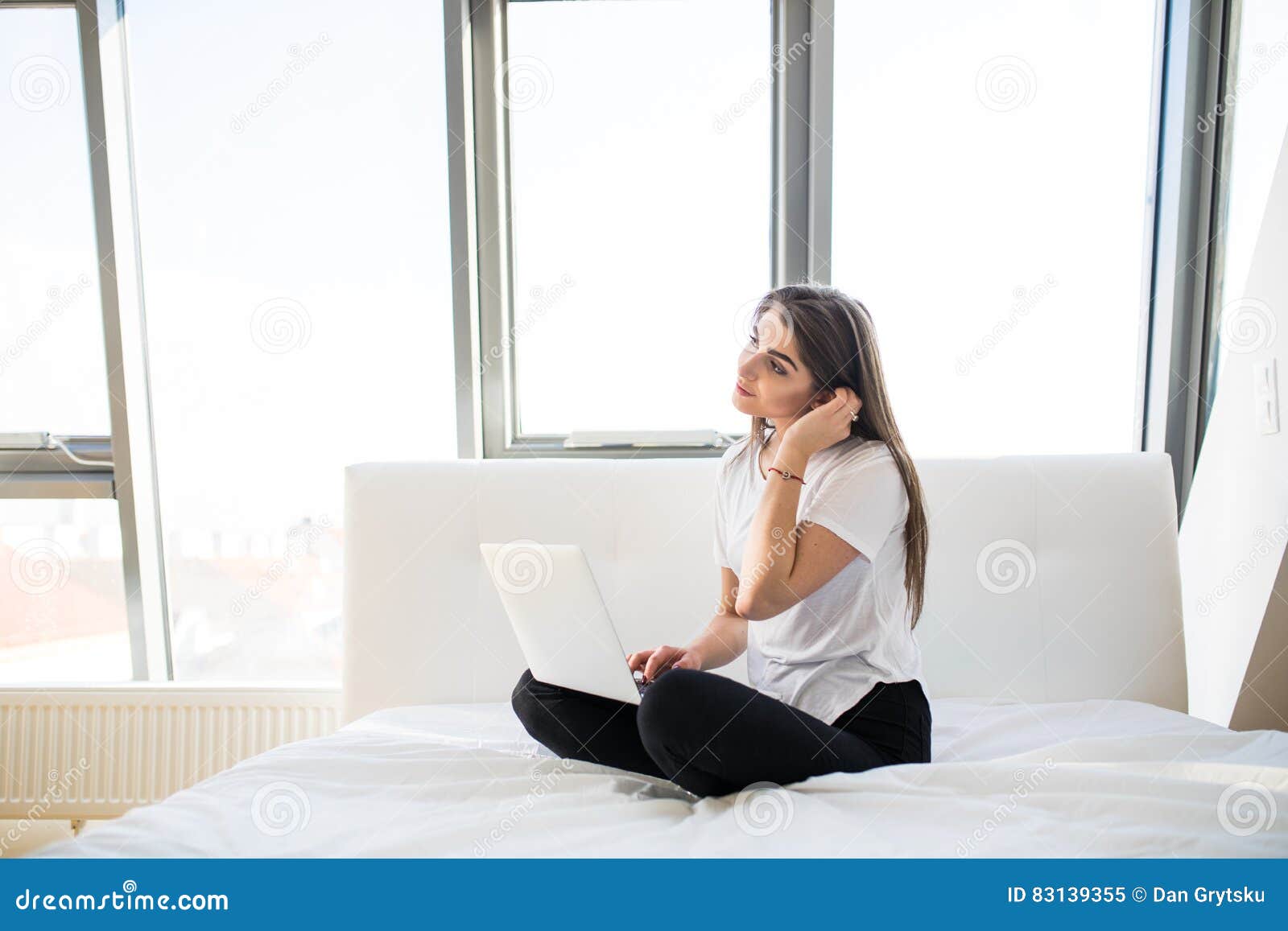 Woman in bed with laptop stock image. Image of computer - 83139355