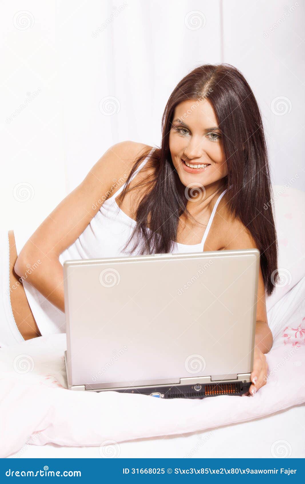 Woman on bed using laptop stock image. Image of female - 31668025