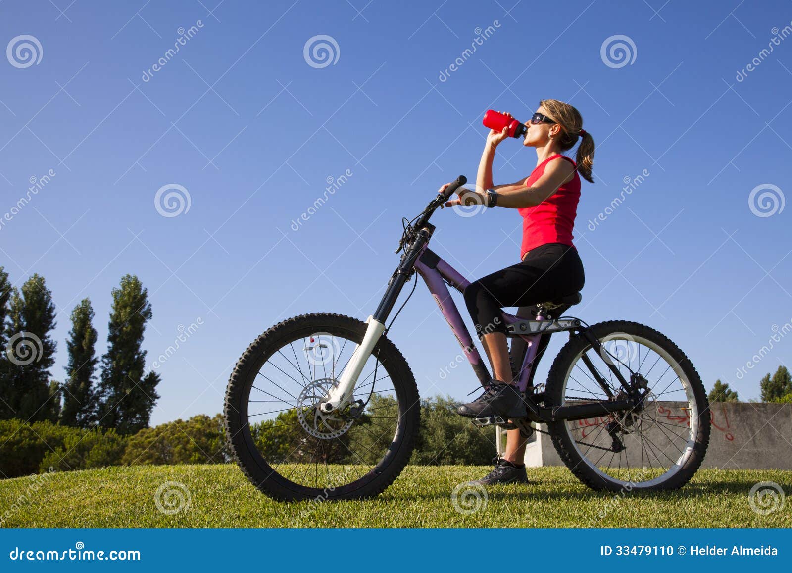 Woman in a bicycle stock photo. Image of drinking, bicycle - 33479110
