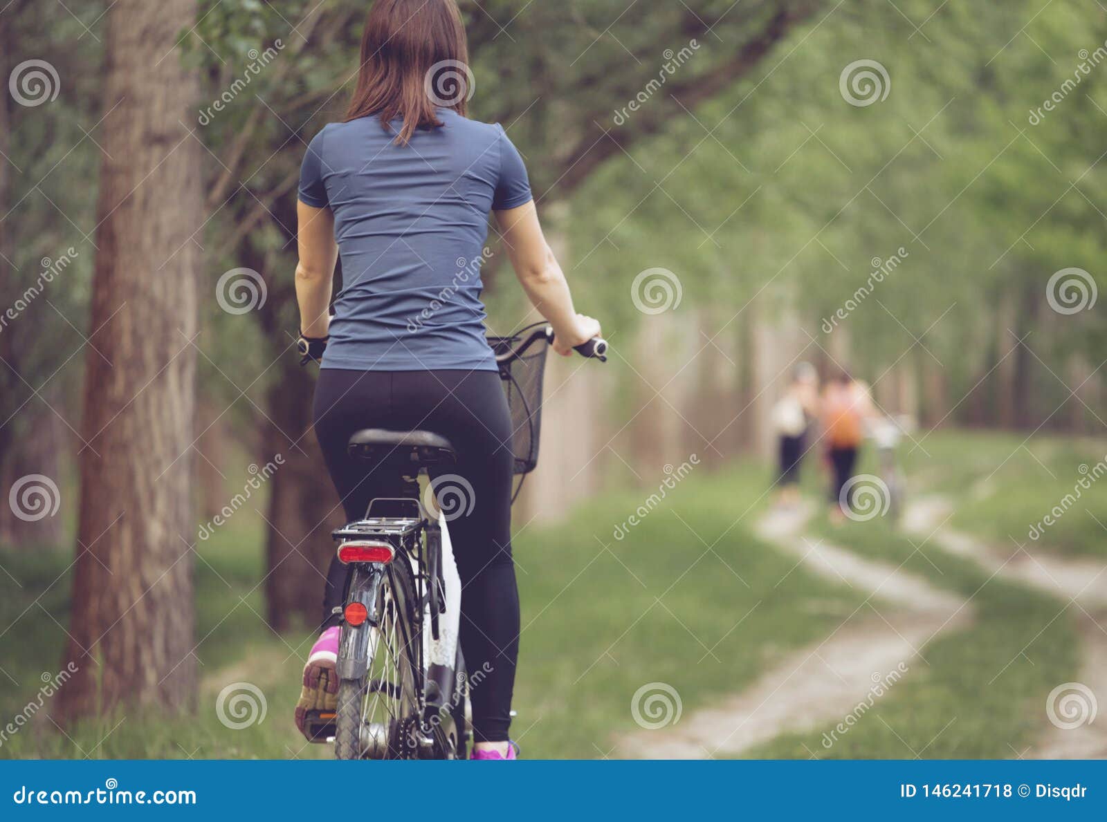 Woman Biker Cycling in Park from Behind Stock Photo - Image of blond ...