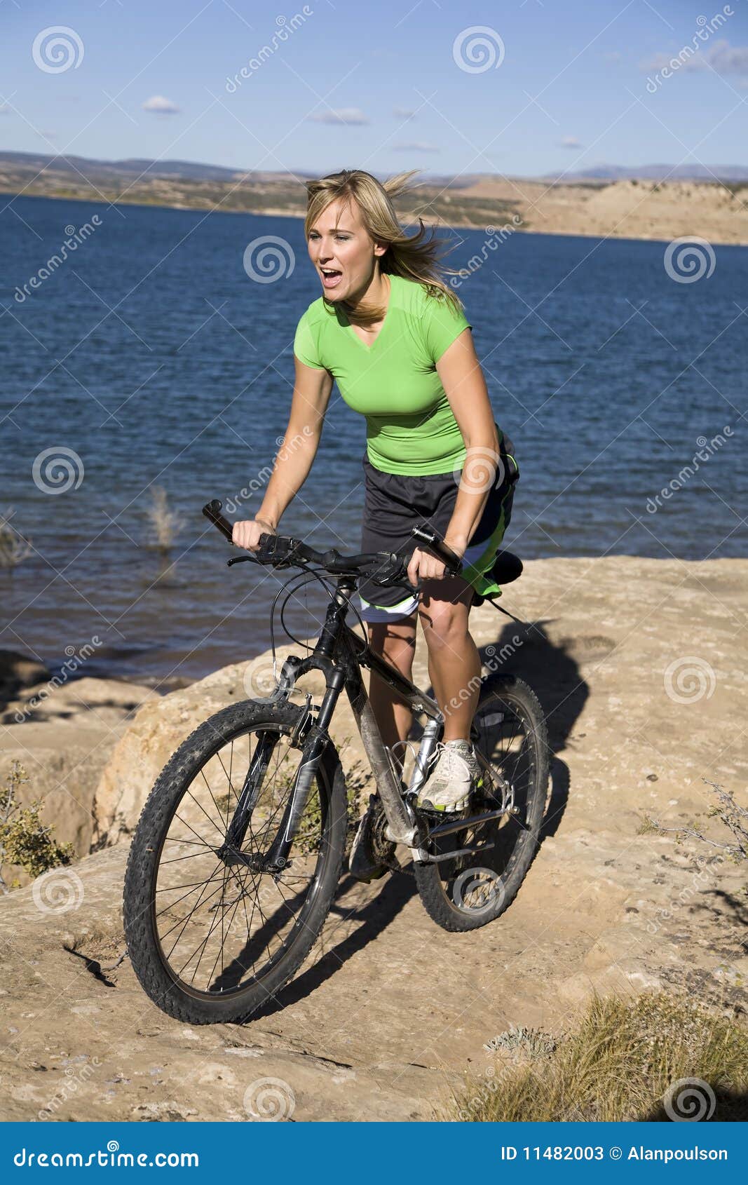 Woman biking on rock stock image. Image of model, horizon - 11482003