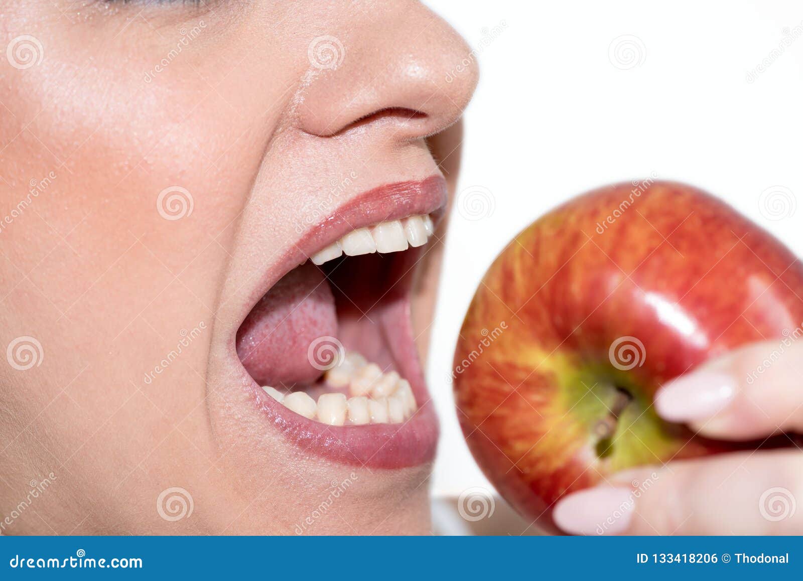 Woman biting an apple stock photo. Image of fresh, biting - 133418206