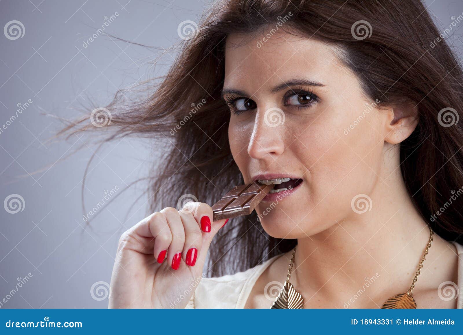 Woman biting chocolate stock image. Image of closeup - 18943331
