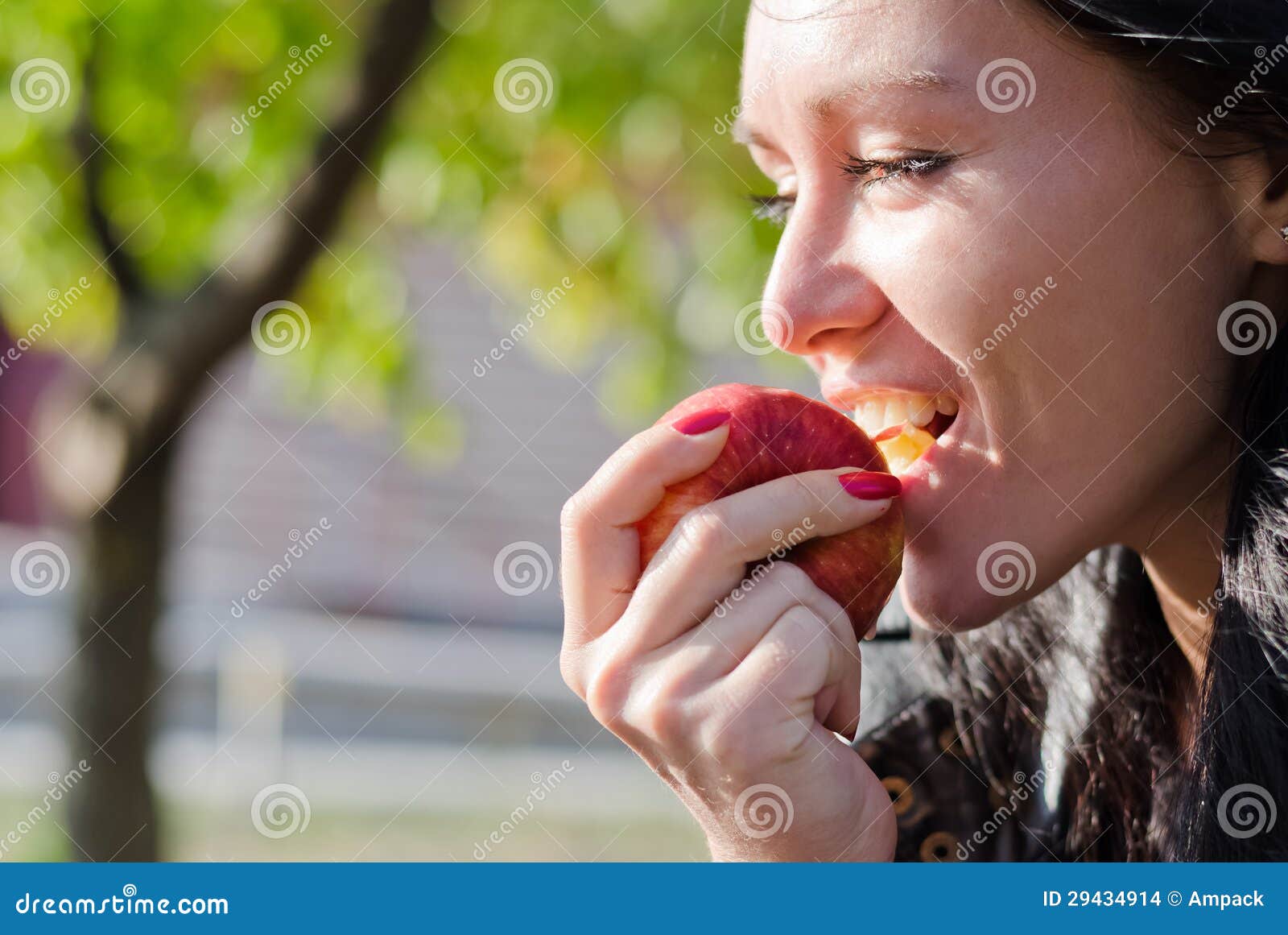 Woman Biting into a Red Apple Stock Photo - Image of brunette ...