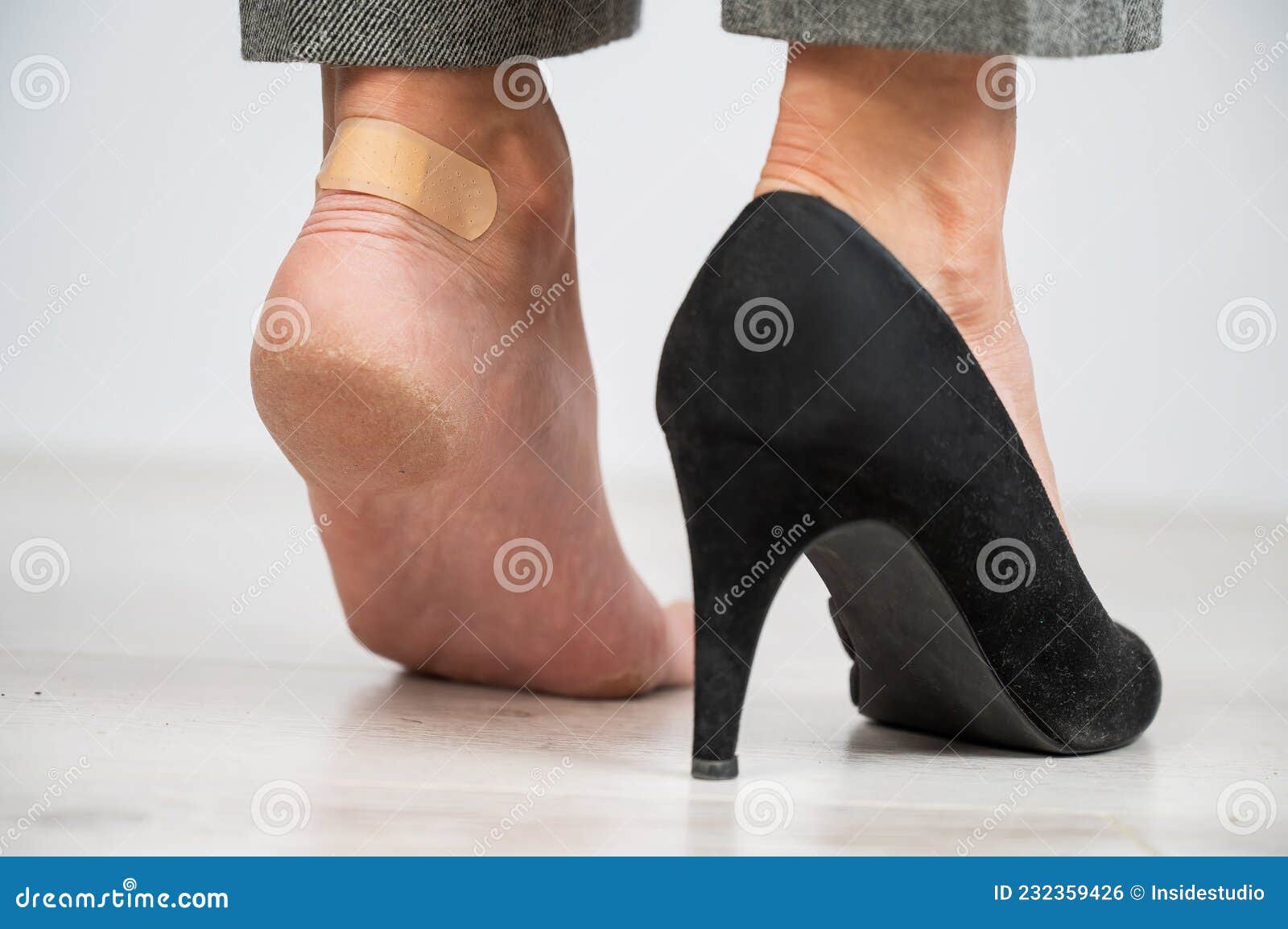 A Woman in Black Shoes Puts a Plaster on a Corn Stock Photo - Image of ...