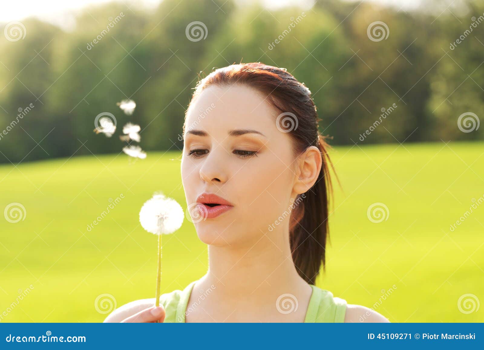Woman Blowing on a Dandelion Stock Image - Image of outdoors, breeze ...