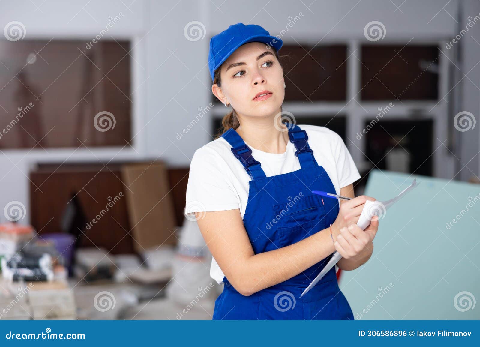 Woman in Blue Overalls Checks the Completed Construction Work on ...