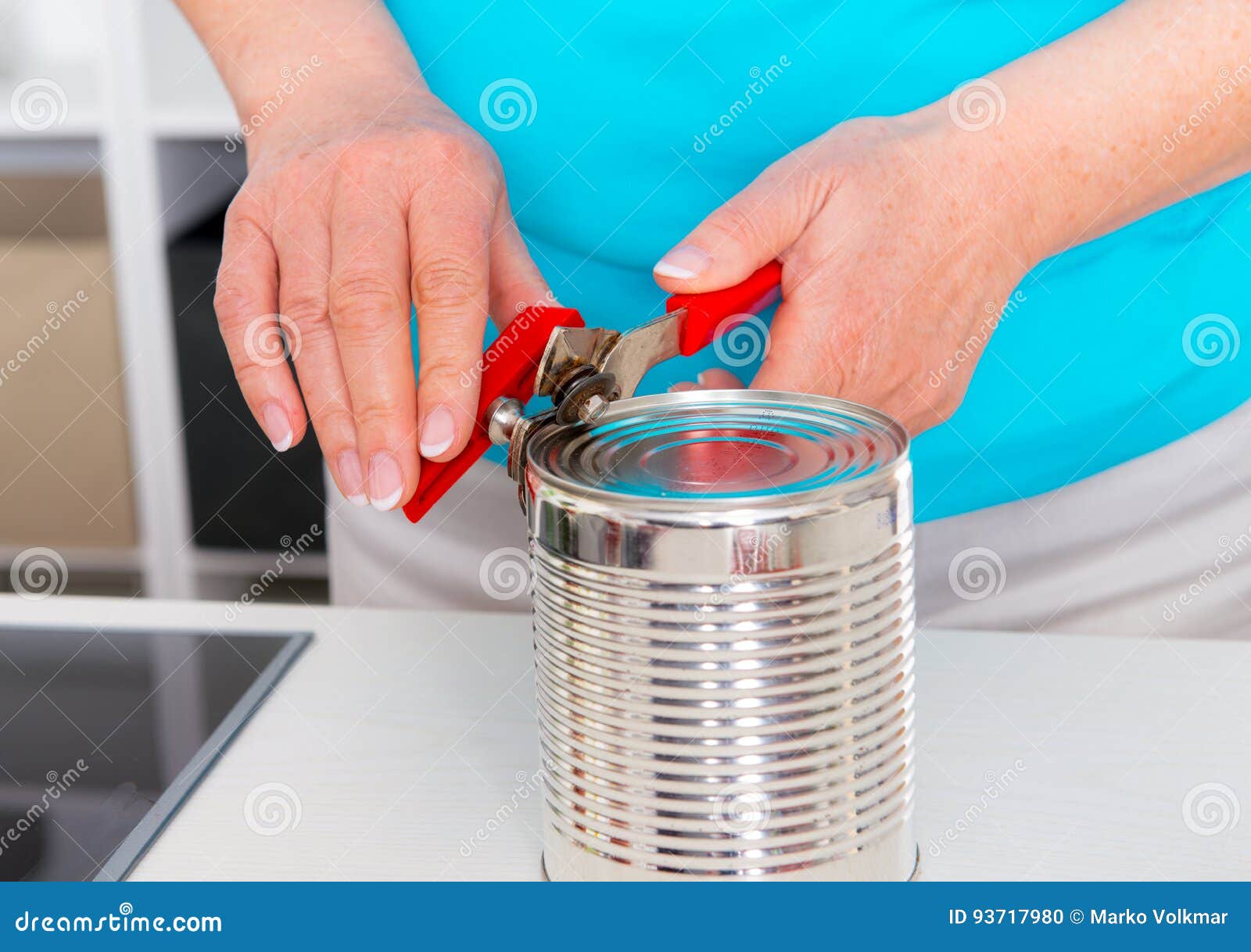 Woman in Blue Shirt Opening a Can in the Kitchen Stock Photo - Image of ...