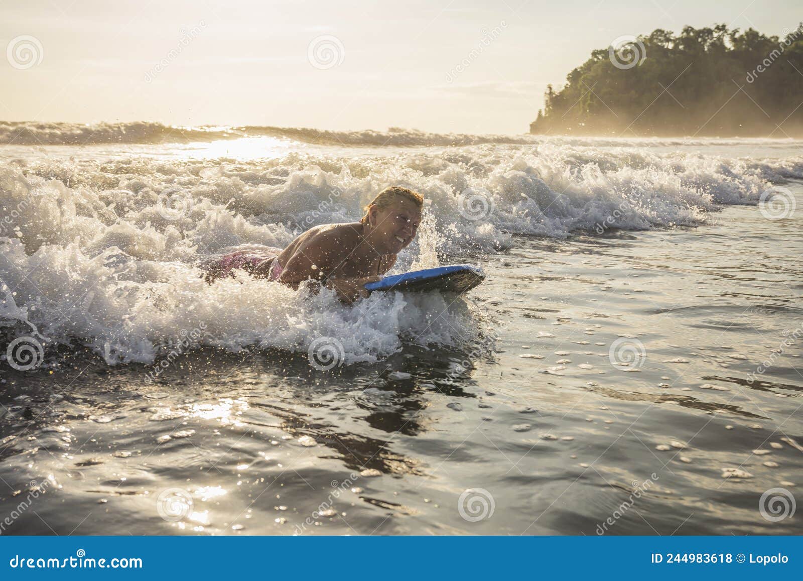 Woman with Boogie Board on the Beach at the Sunset Stock Photo - Image ...