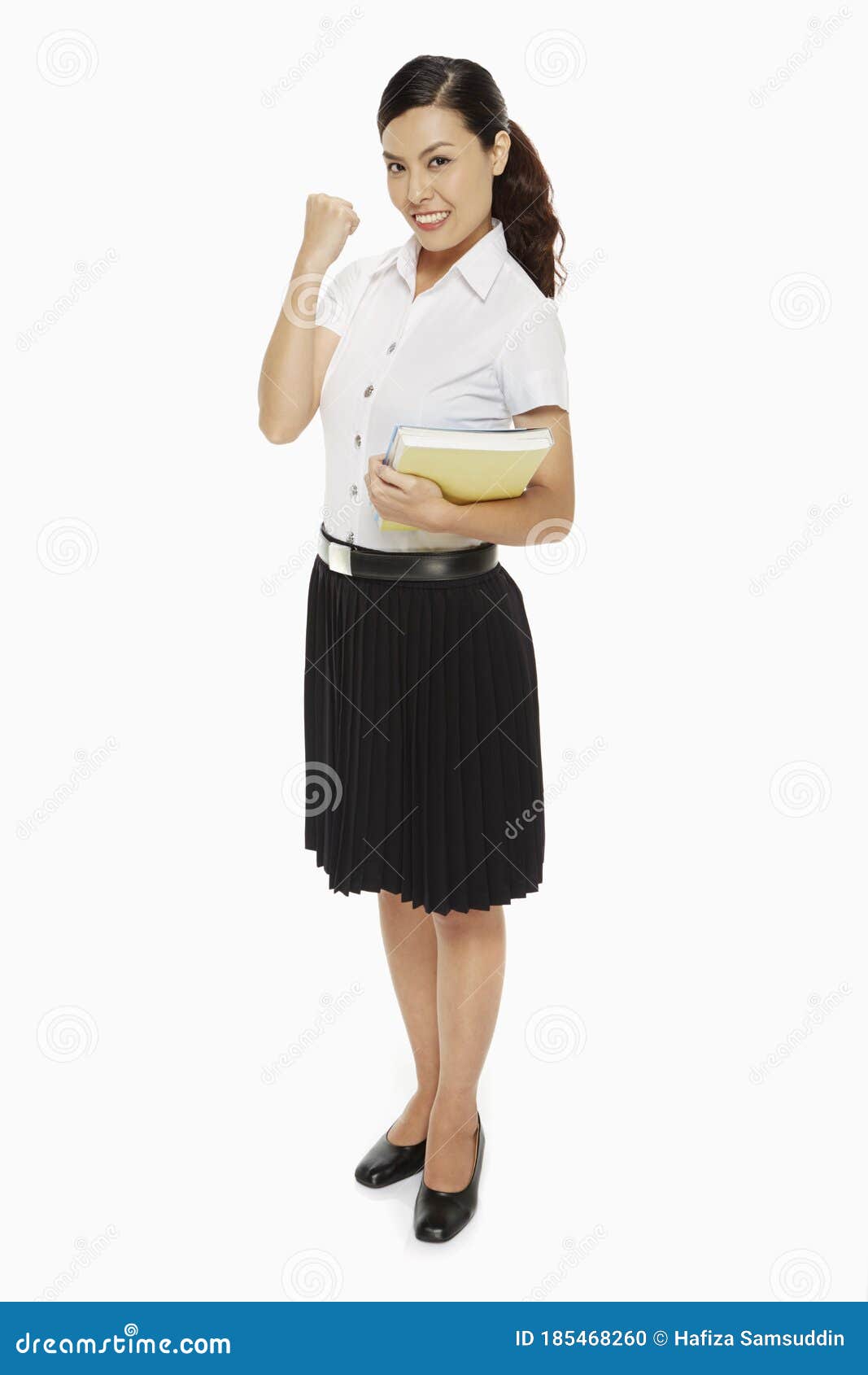 Woman with books cheering stock photo. Image of gesturing - 185468260
