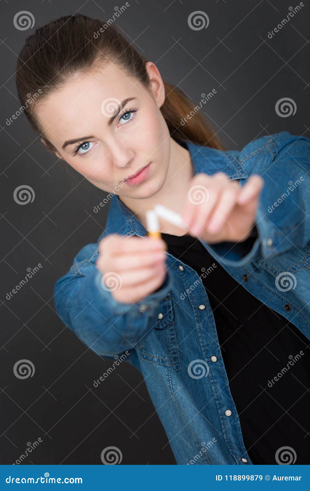Woman breaking a cigarette stock image. Image of danger - 118899879