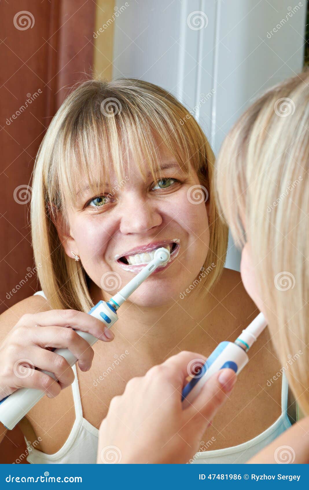 Woman brushing teeth stock photo. Image of camera, female - 47481986