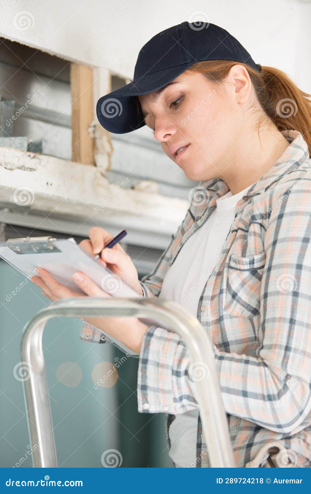 Woman Builder Writing on Clipboard on Stepladder Stock Photo - Image of ...
