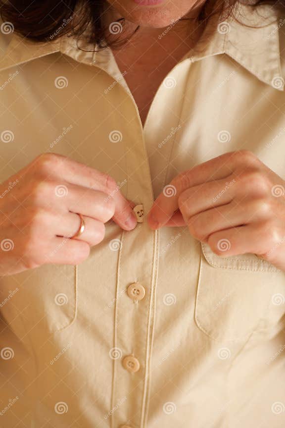 Woman buttoning shirt stock image. Image of breasts, dress - 19087977