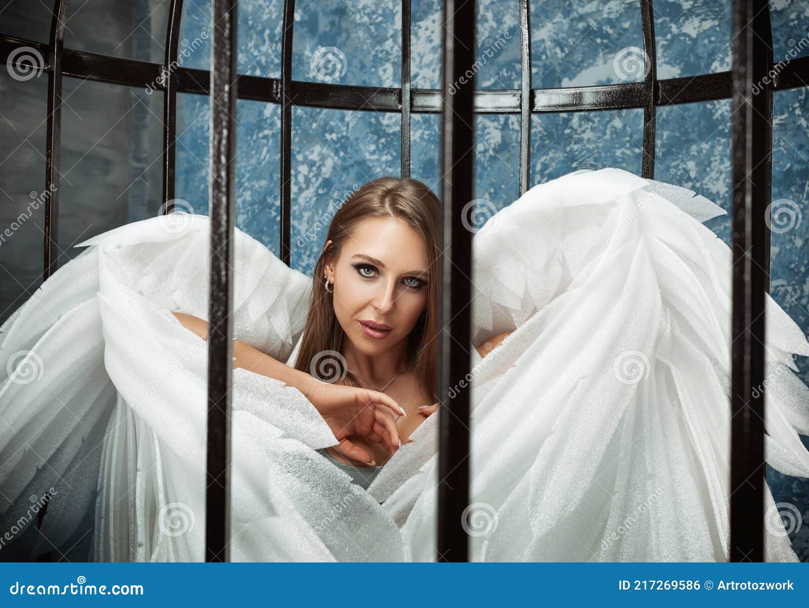 A Woman in a Cage with Angel Wings Stock Photo - Image of metal ...