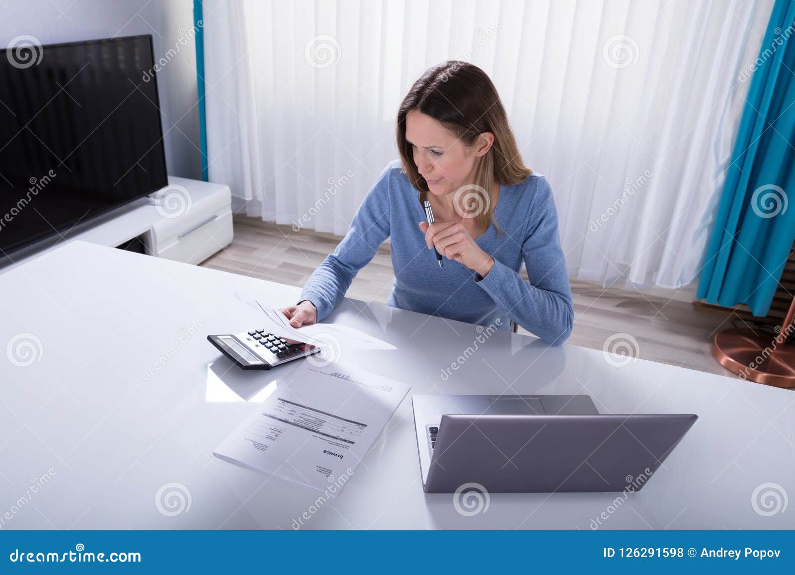 Woman Calculating Invoice with Calculator at Home Stock Photo - Image ...