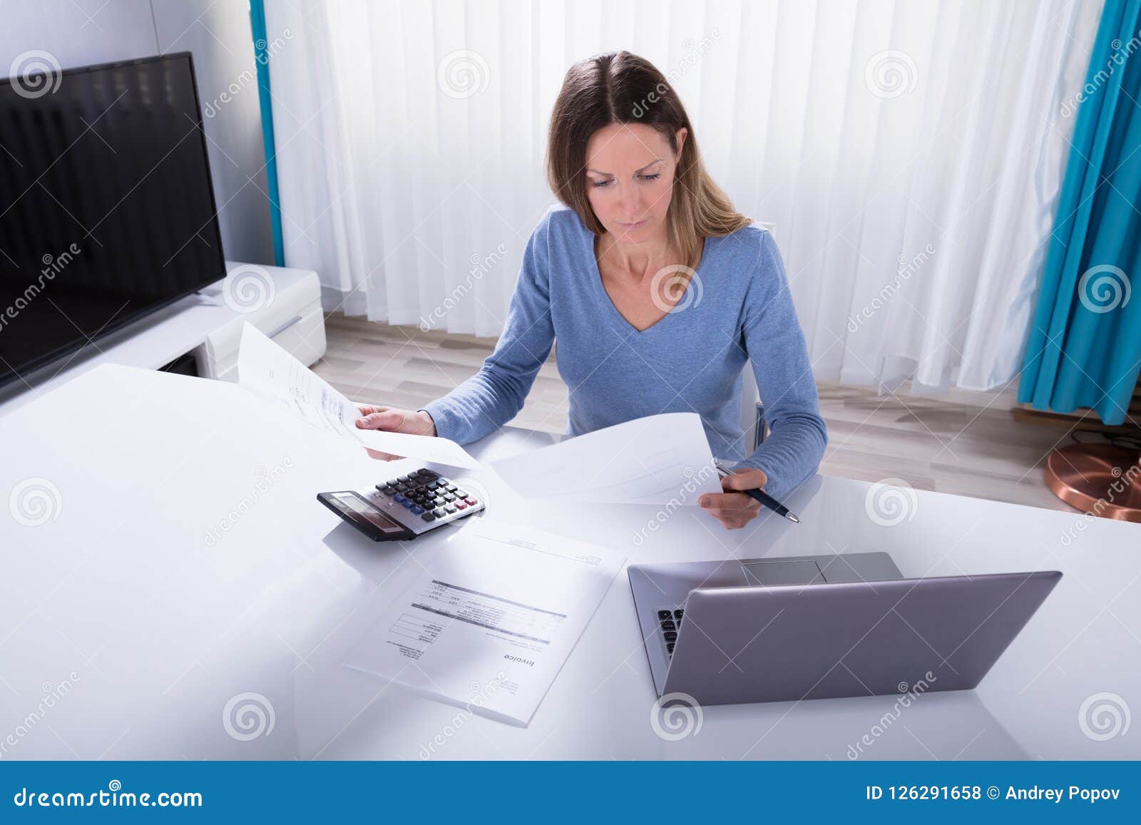 Woman Calculating Invoice with Calculator at Home Stock Photo - Image ...