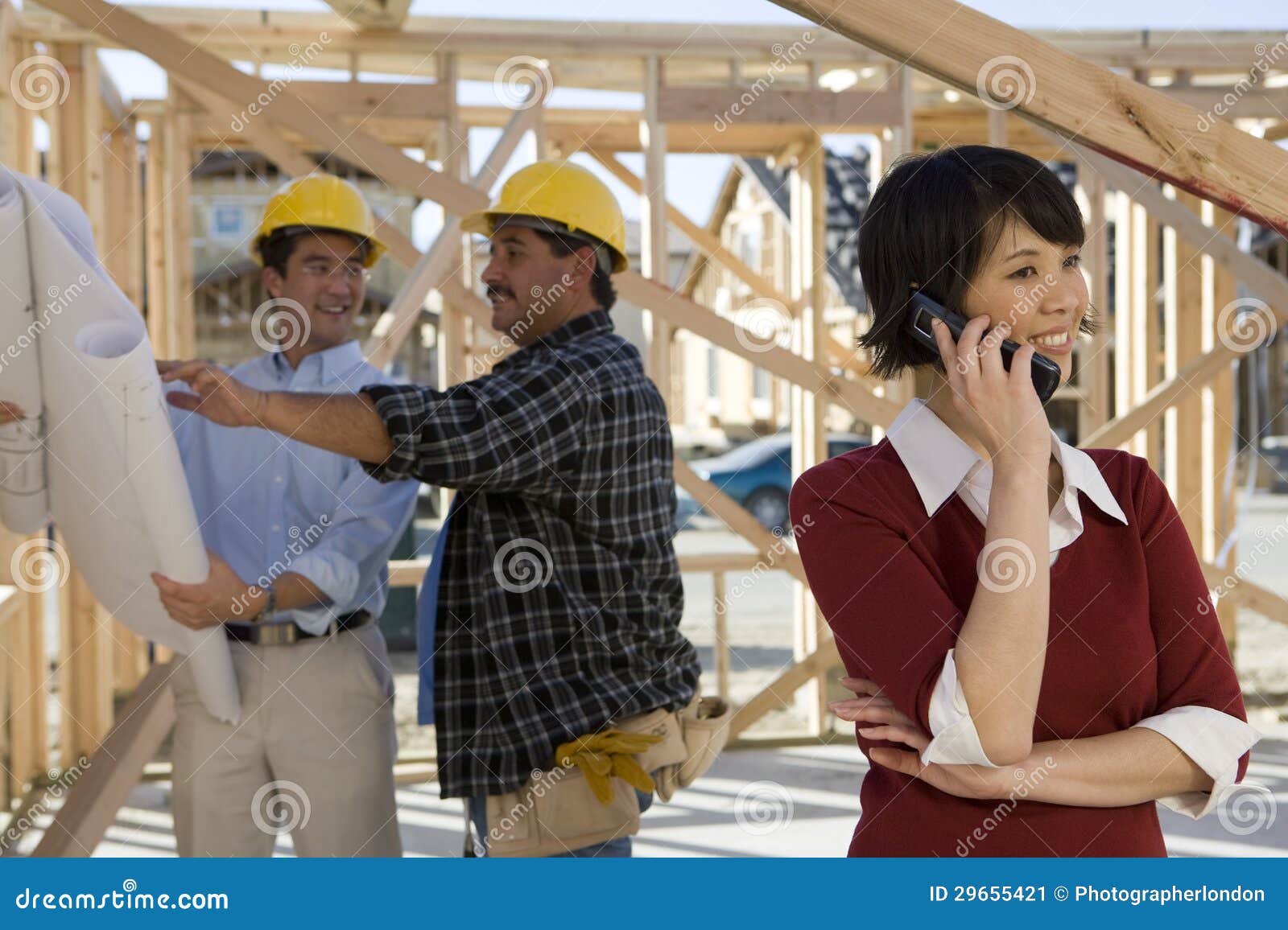 Woman on Call with Contractors in Background Stock Image - Image of ...
