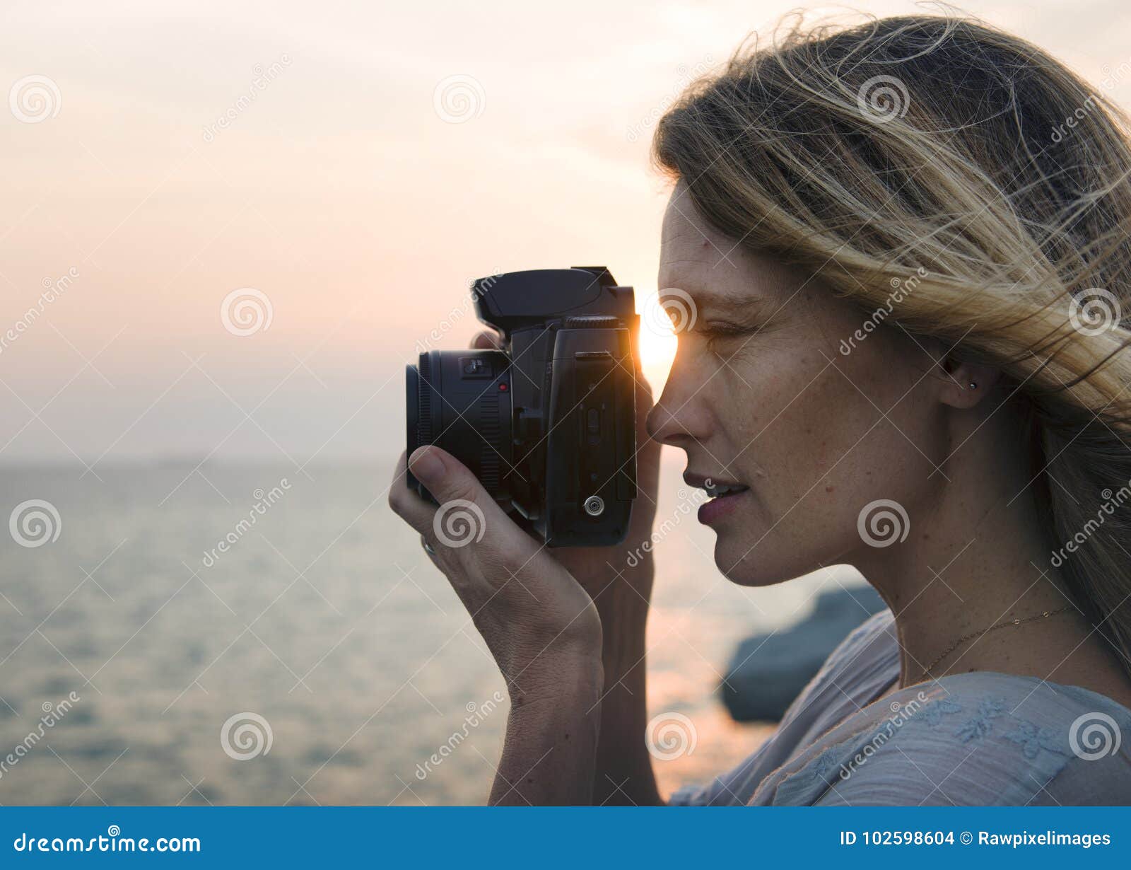 Woman with Camera Shooting on the Beach Stock Photo - Image of peaceful ...