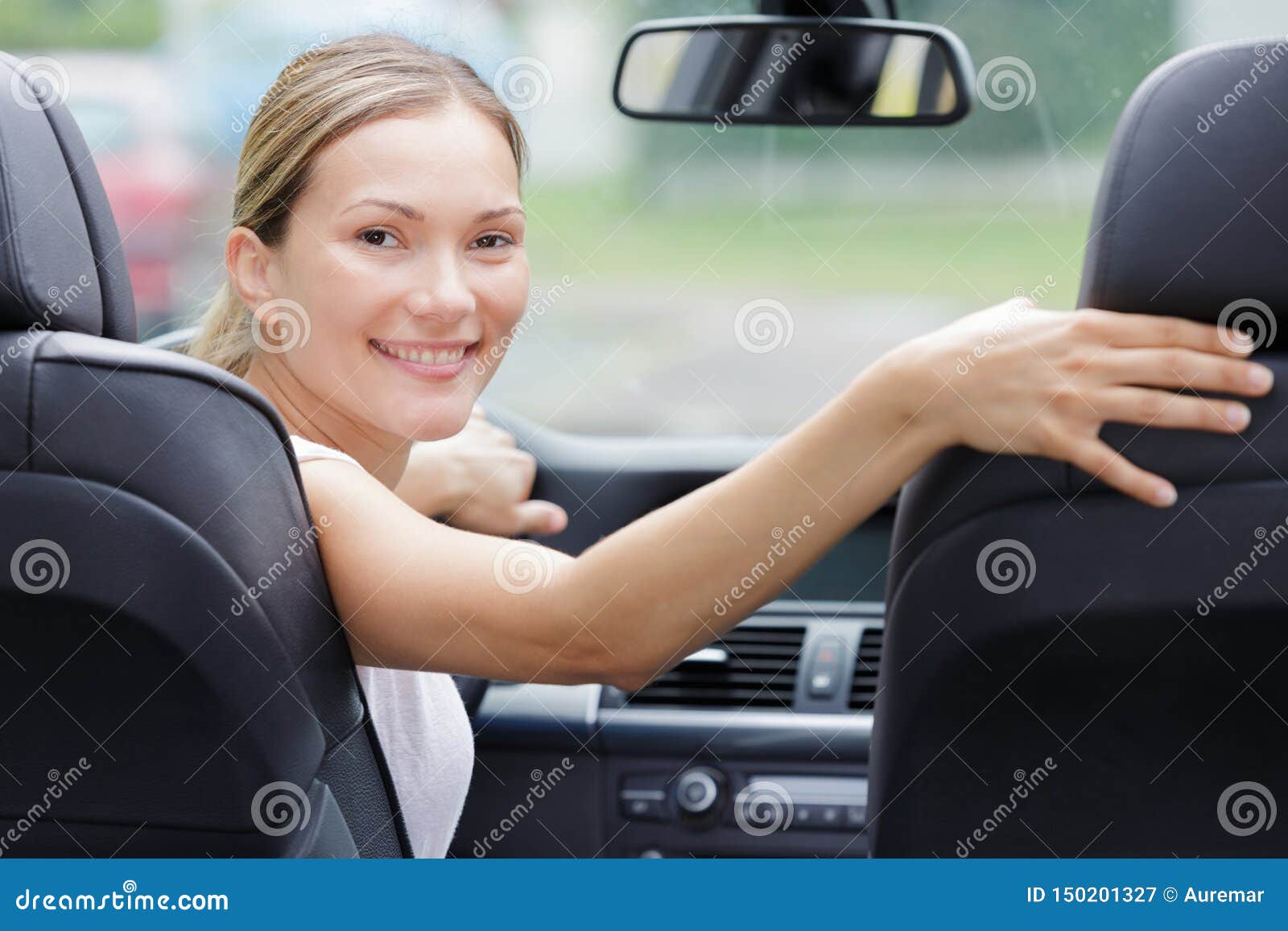 Woman in car looking back stock image. Image of portrait - 150201327