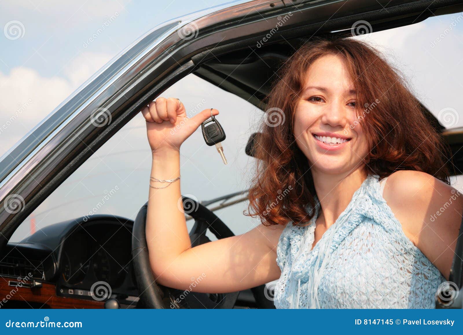 Woman in car shows a key stock image. Image of excitement - 8147145