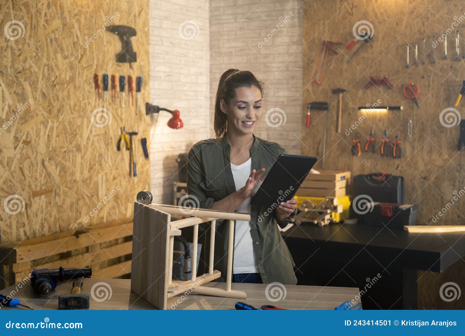Woman Carpenter in Workshop Holding and Looking at Tablet Stock Image ...