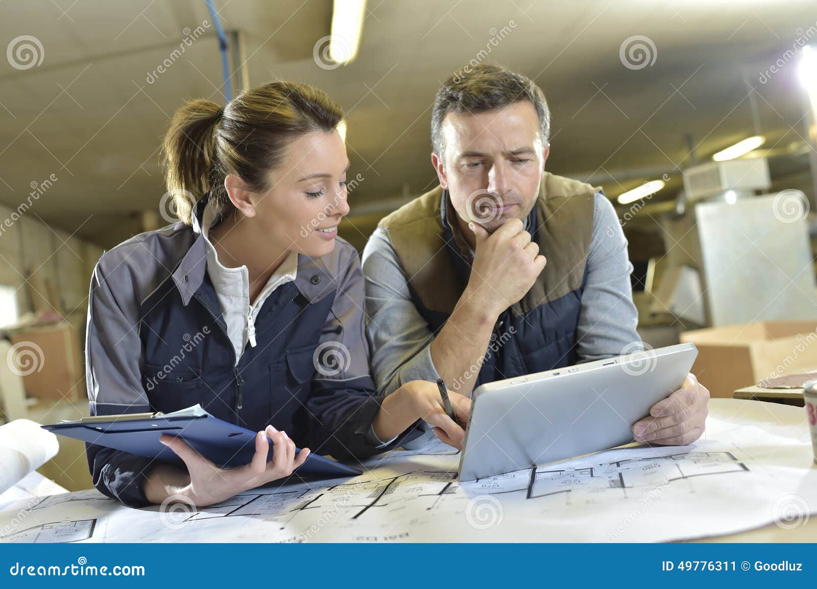 Woman and Carpentry Instructor Discussing and Working on Tablet Stock ...