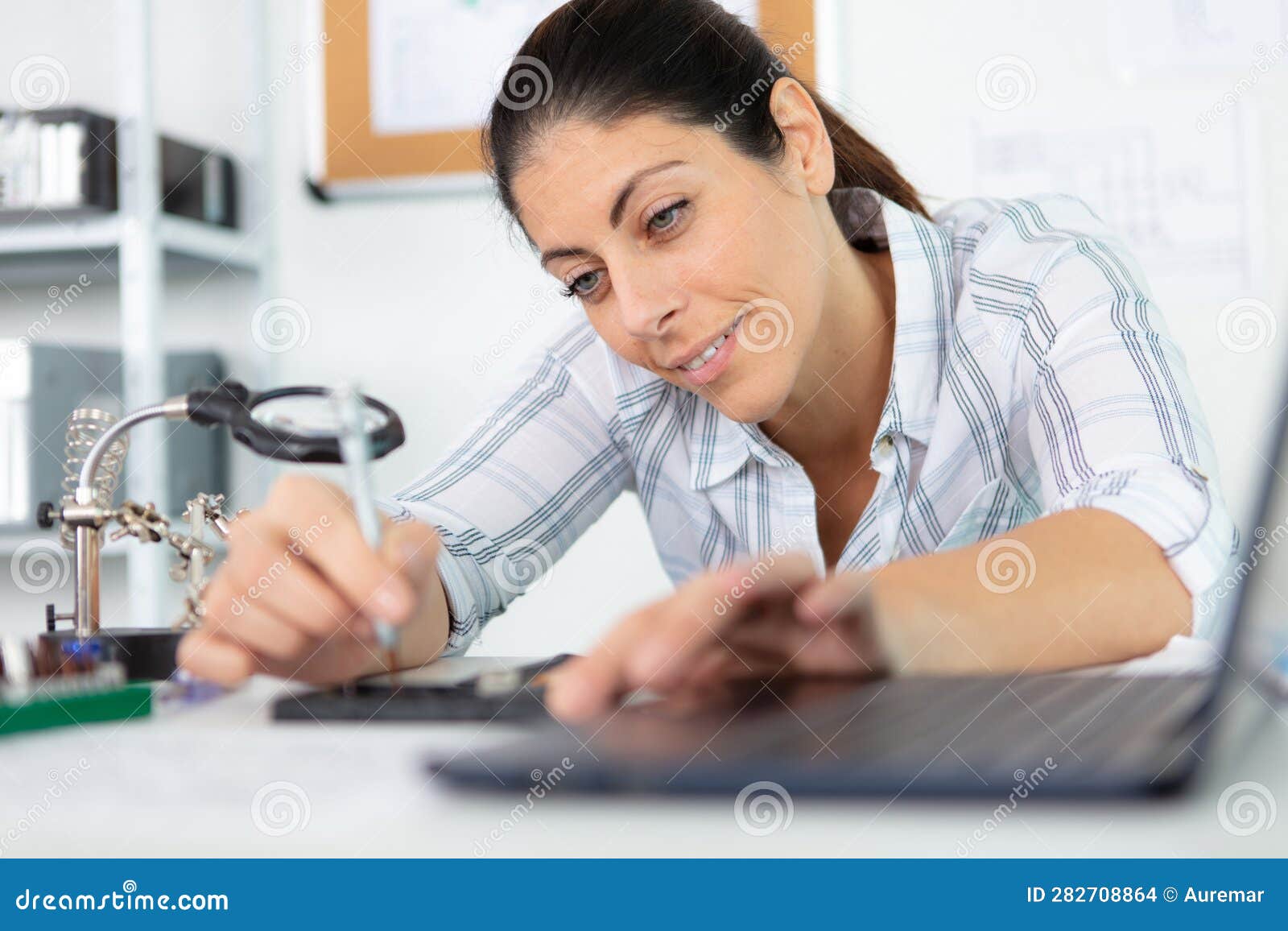 Woman Carrying Out Precision Computer Repair Stock Photo - Image of device, plumb: 282708864