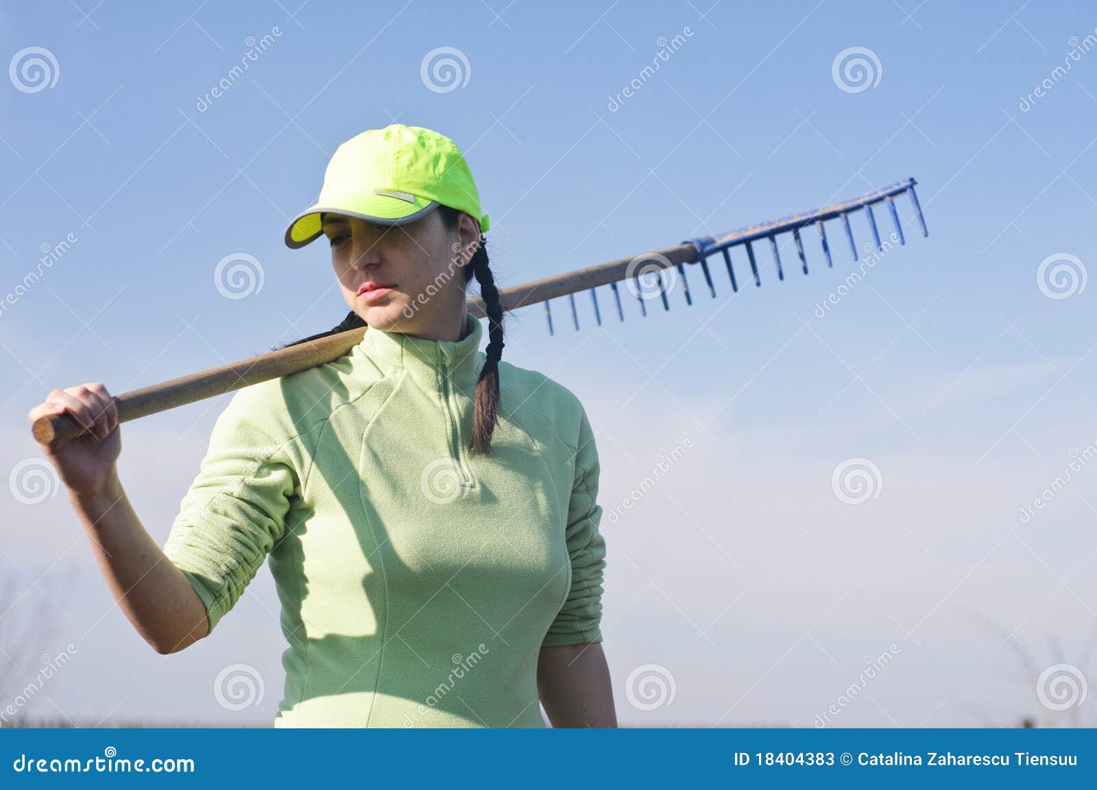 Woman carrying wooden rake stock image. Image of serious - 18404383