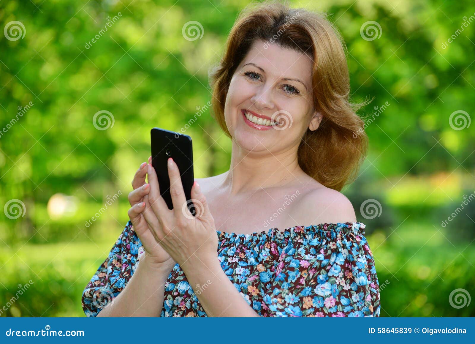Woman with a Cell Phone in Nature at the Summer Stock Image - Image of ...