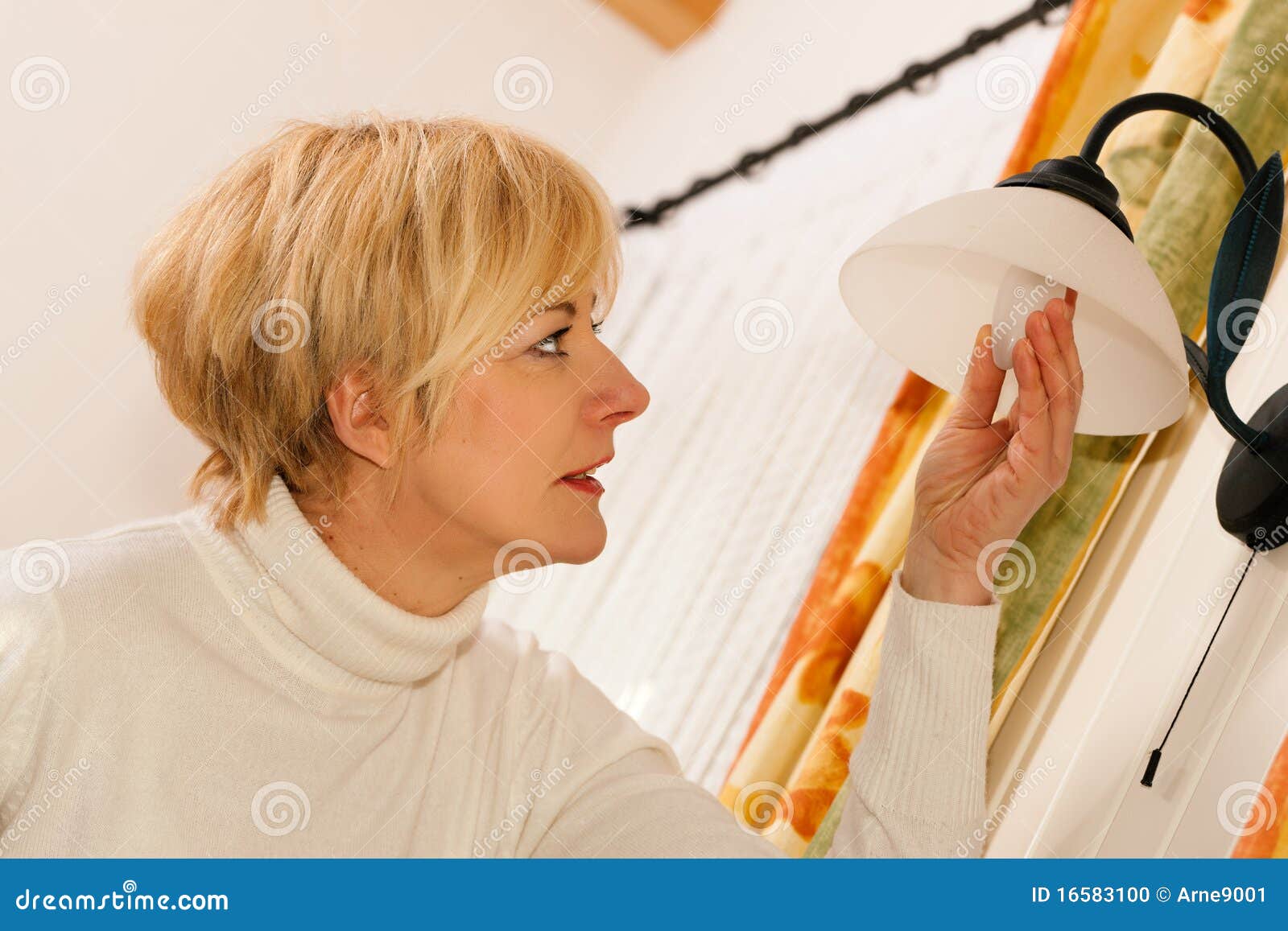 Woman Changing a Light Bulb Stock Photo - Image of repair, person: 16583100