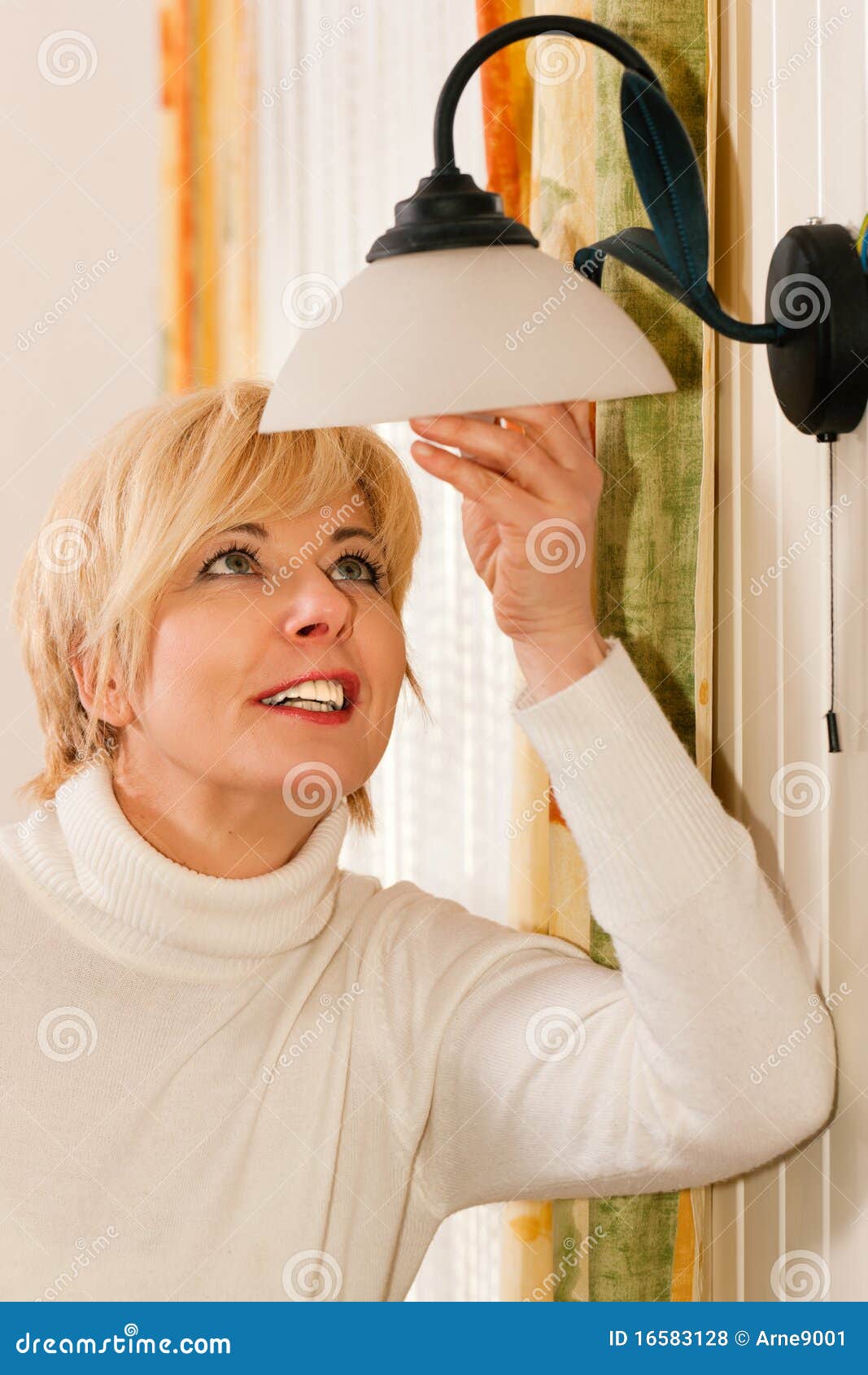 Woman Changing a Light Bulb Stock Photo - Image of homemaker, female ...
