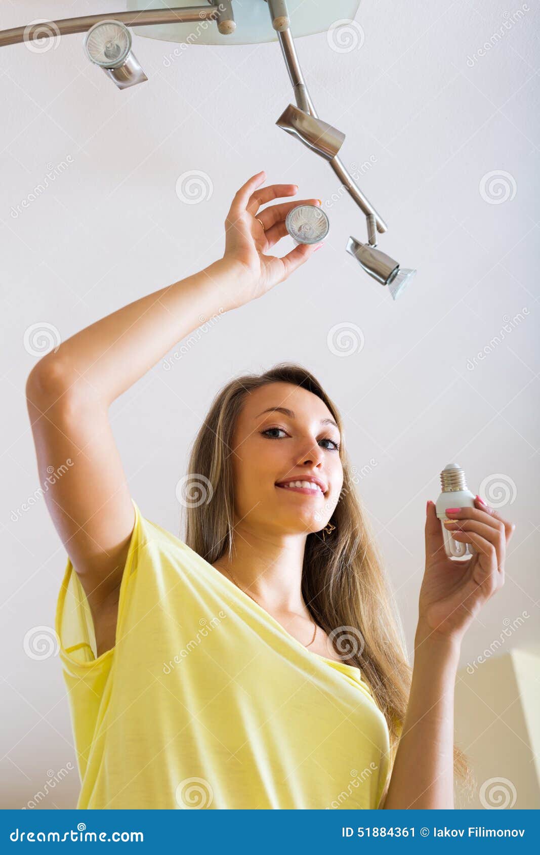 Woman changing light bulbs stock image. Image of change - 51884361