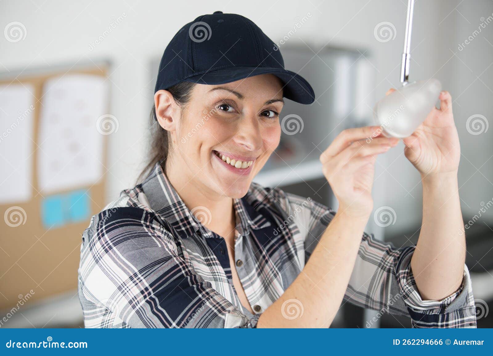 Woman changing lightbulb stock photo. Image of suspended - 262294666