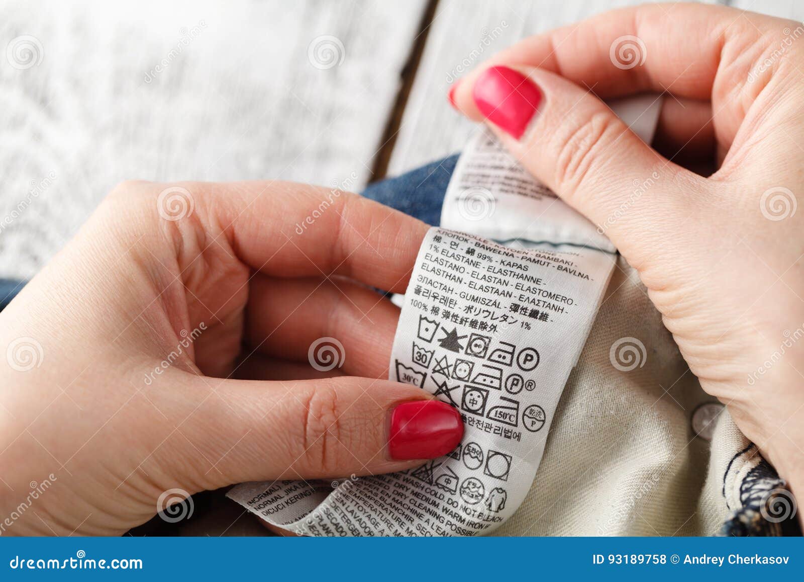 Woman Checking the Care Label of a Pair of Jeans Stock Photo - Image of ...
