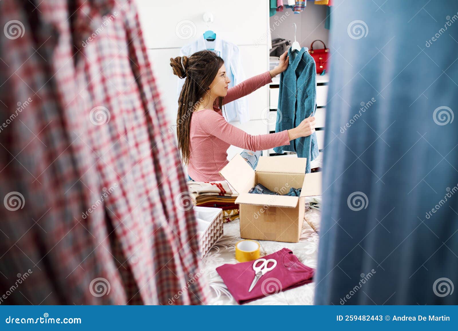 Woman Putting Used Clothes in a Box Stock Image - Image of reselling ...