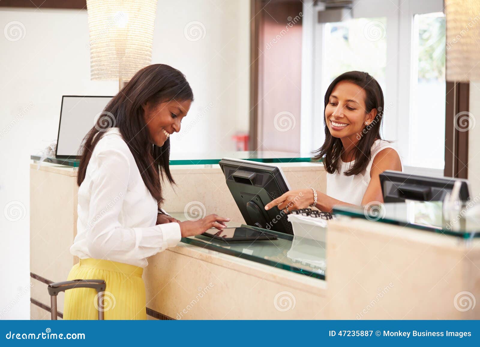 Woman Checking in at Hotel Reception Using Digital Tablet Stock Image ...