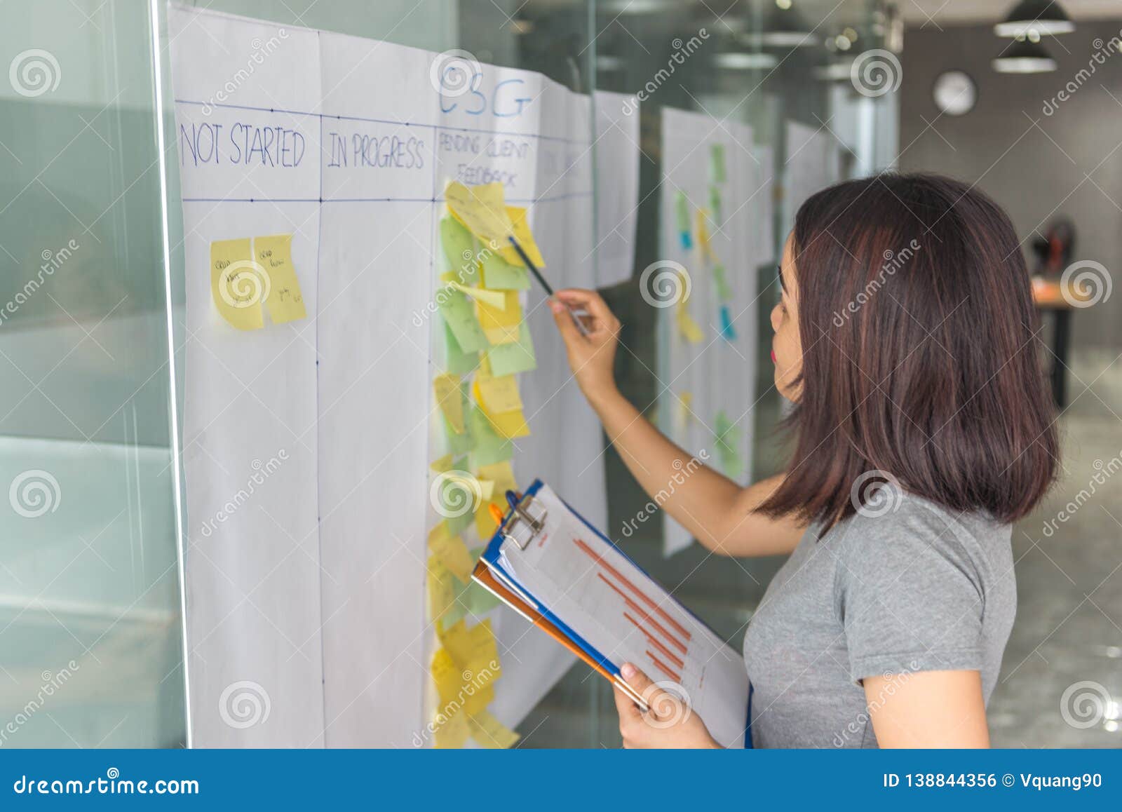 Woman Checking Information in Document with Sticky Notes Stock Photo ...
