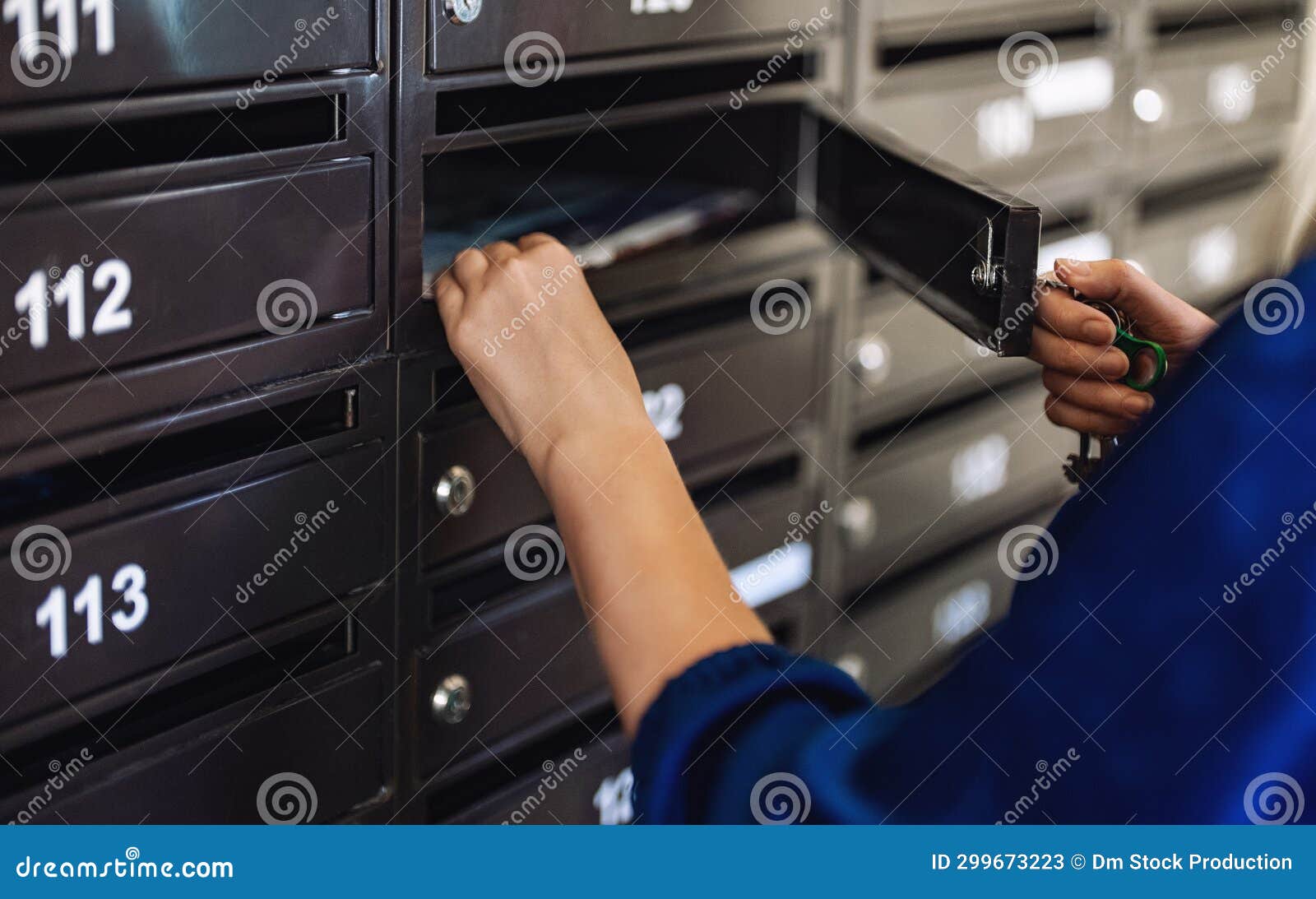 Woman checking mailbox stock image. Image of postbox - 299673223