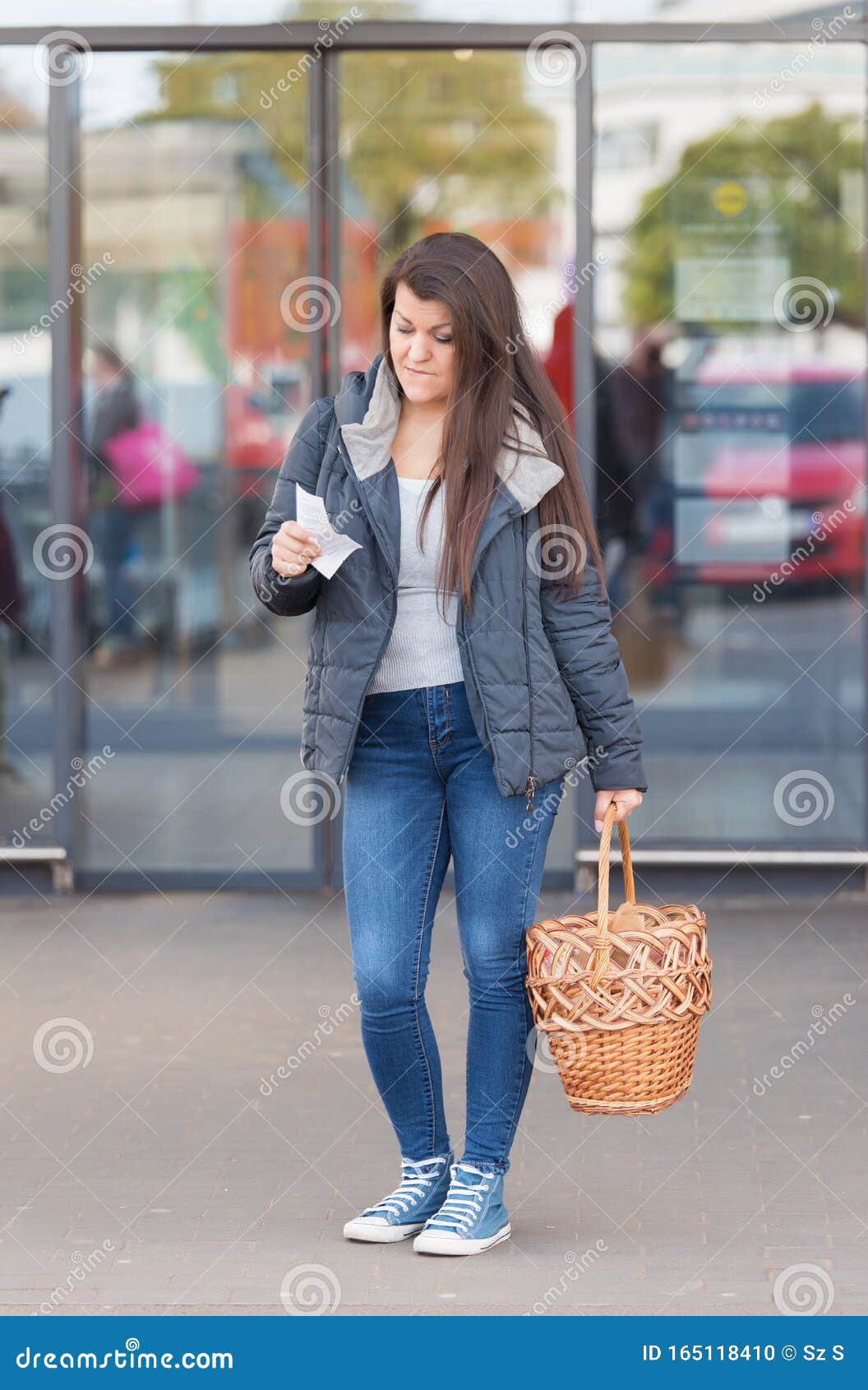 Woman checking a receipt stock photo. Image of read - 165118410