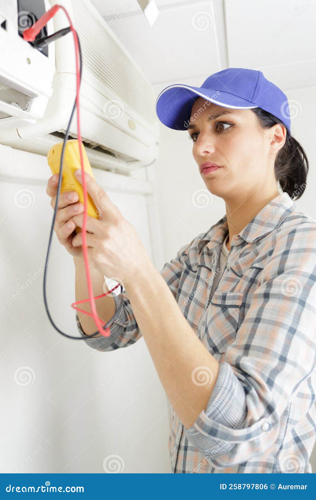 Woman Checking Voltage in Power Socket Stock Photo - Image of ...