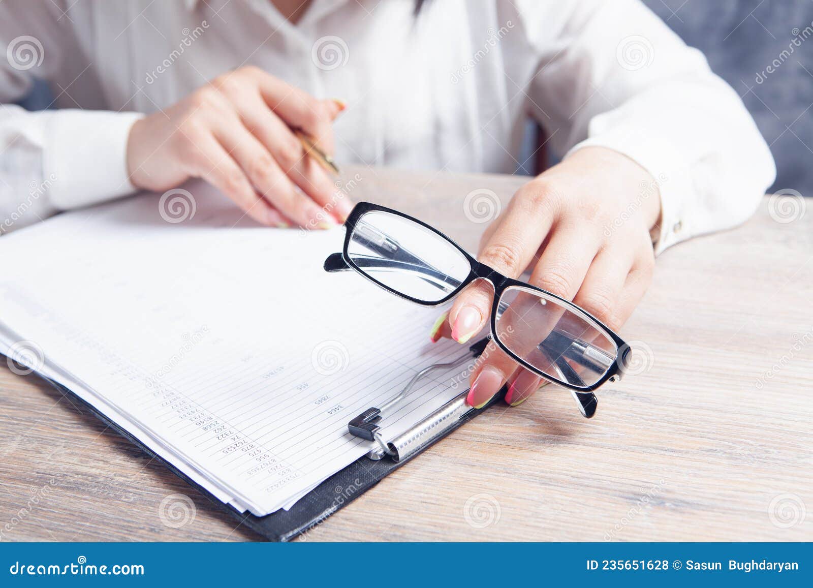 Woman Checks Papers in Front of the Table. Optical Glasses Stock Photo ...
