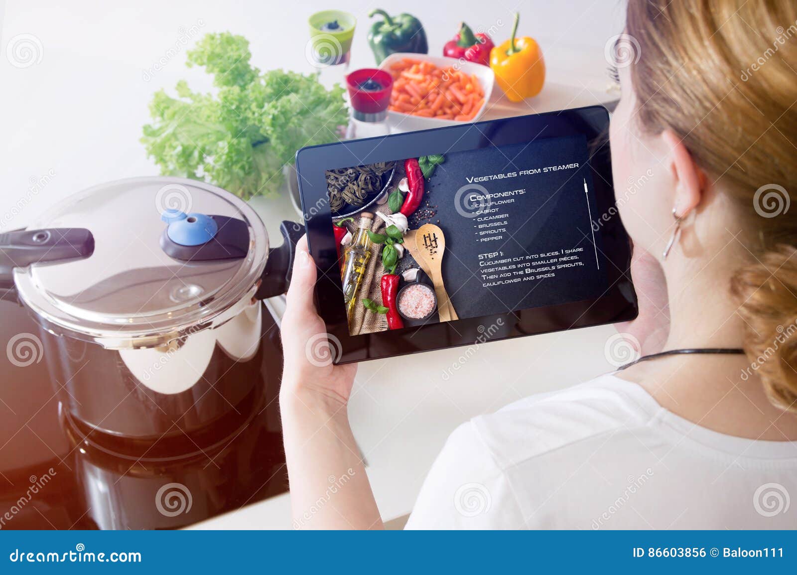 Woman checks the recipe stock photo. Image of vegetables - 86603856