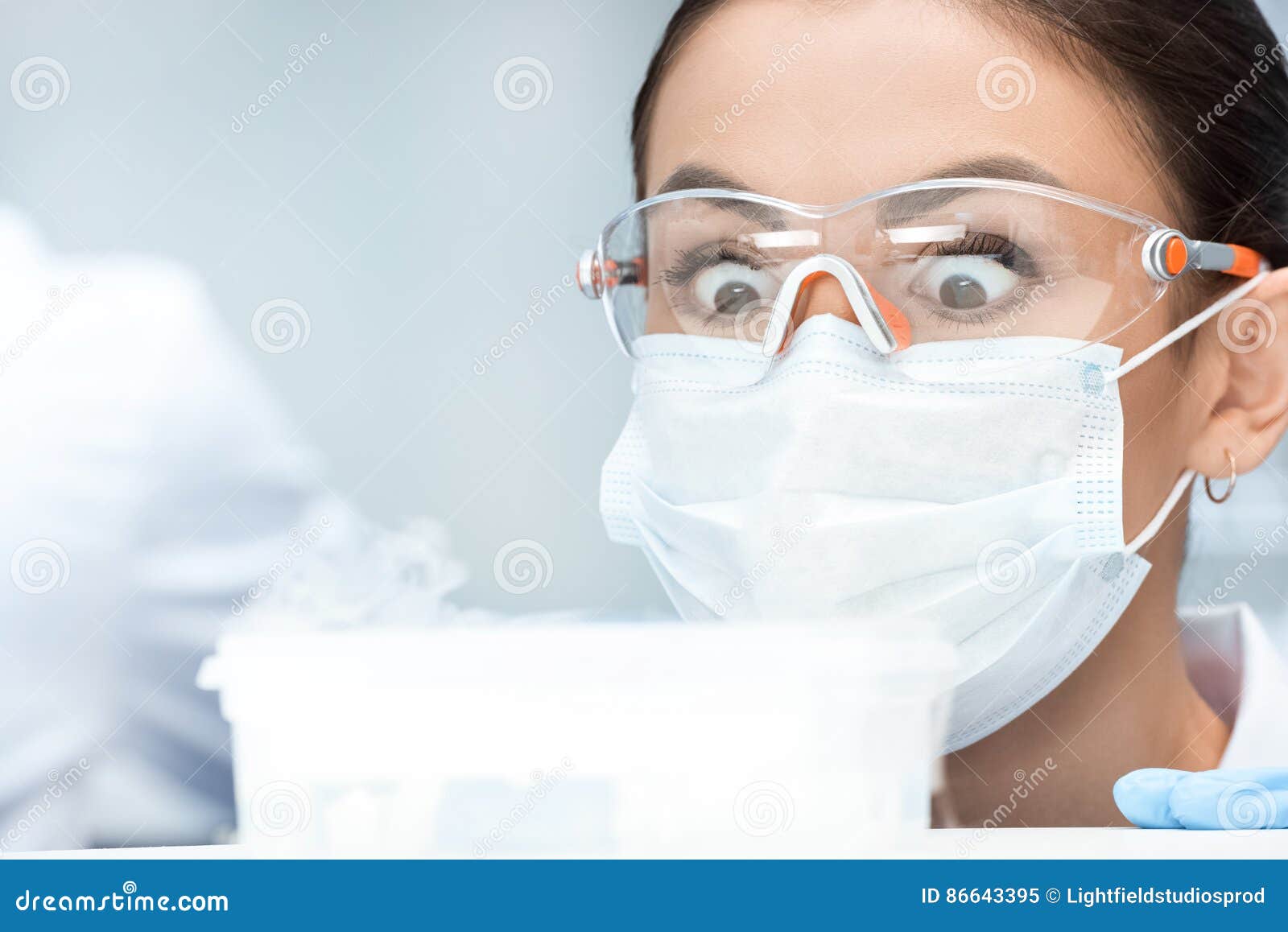 Woman Chemist in Protective Goggles and Mask Making Experiment in ...