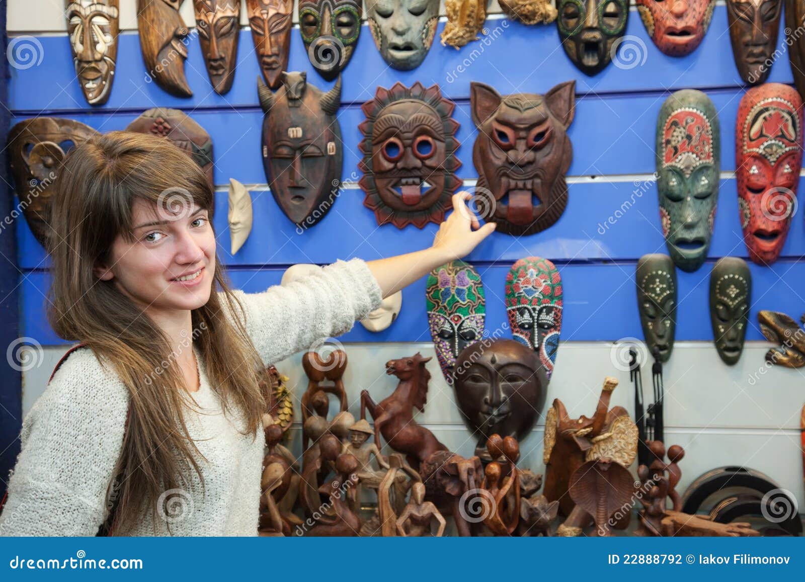 Woman chooses African mask stock photo. Image of caucasian - 22888792