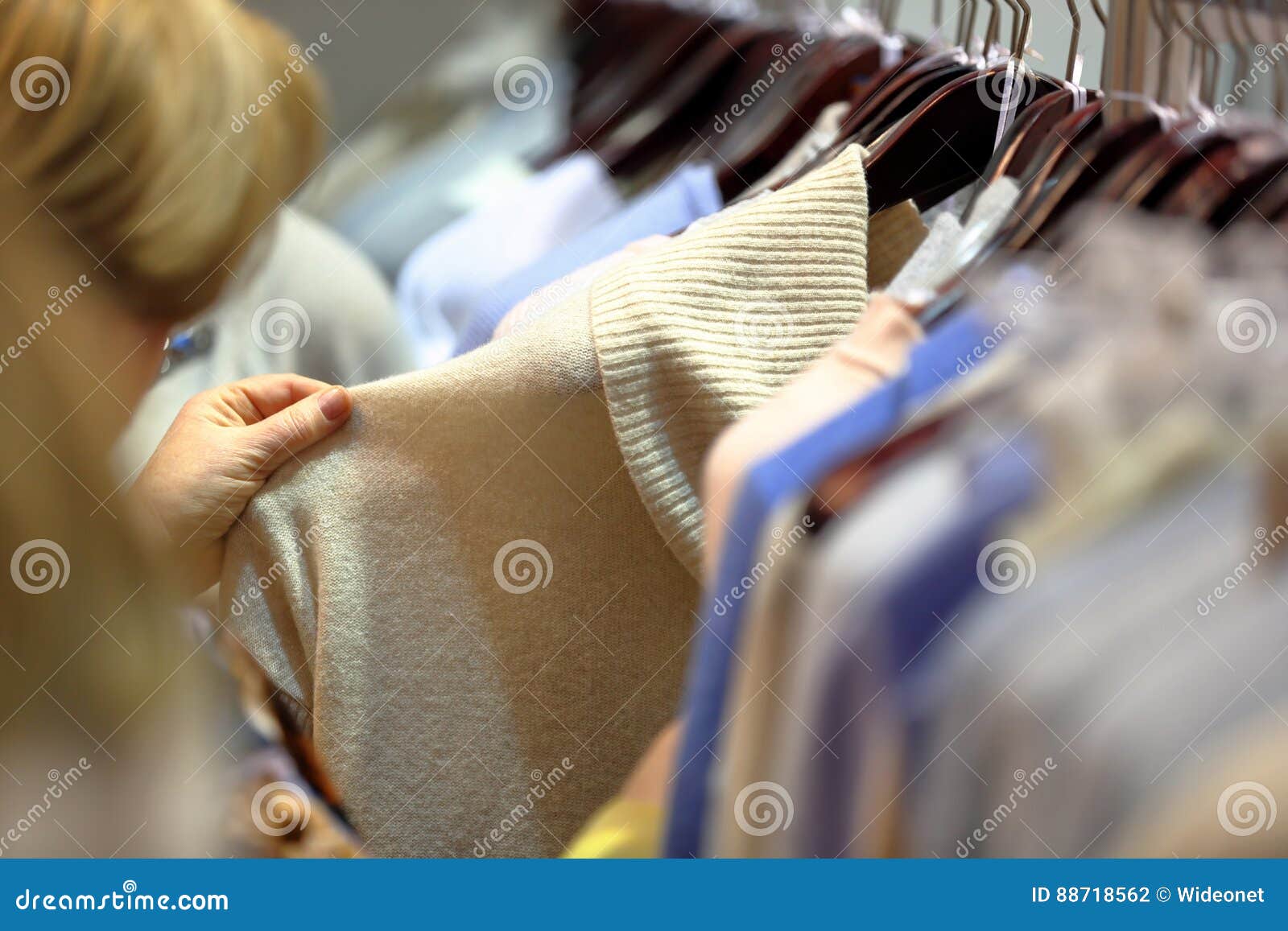 Woman Chooses Clothes in Store Stock Photo - Image of boutique, hanging ...