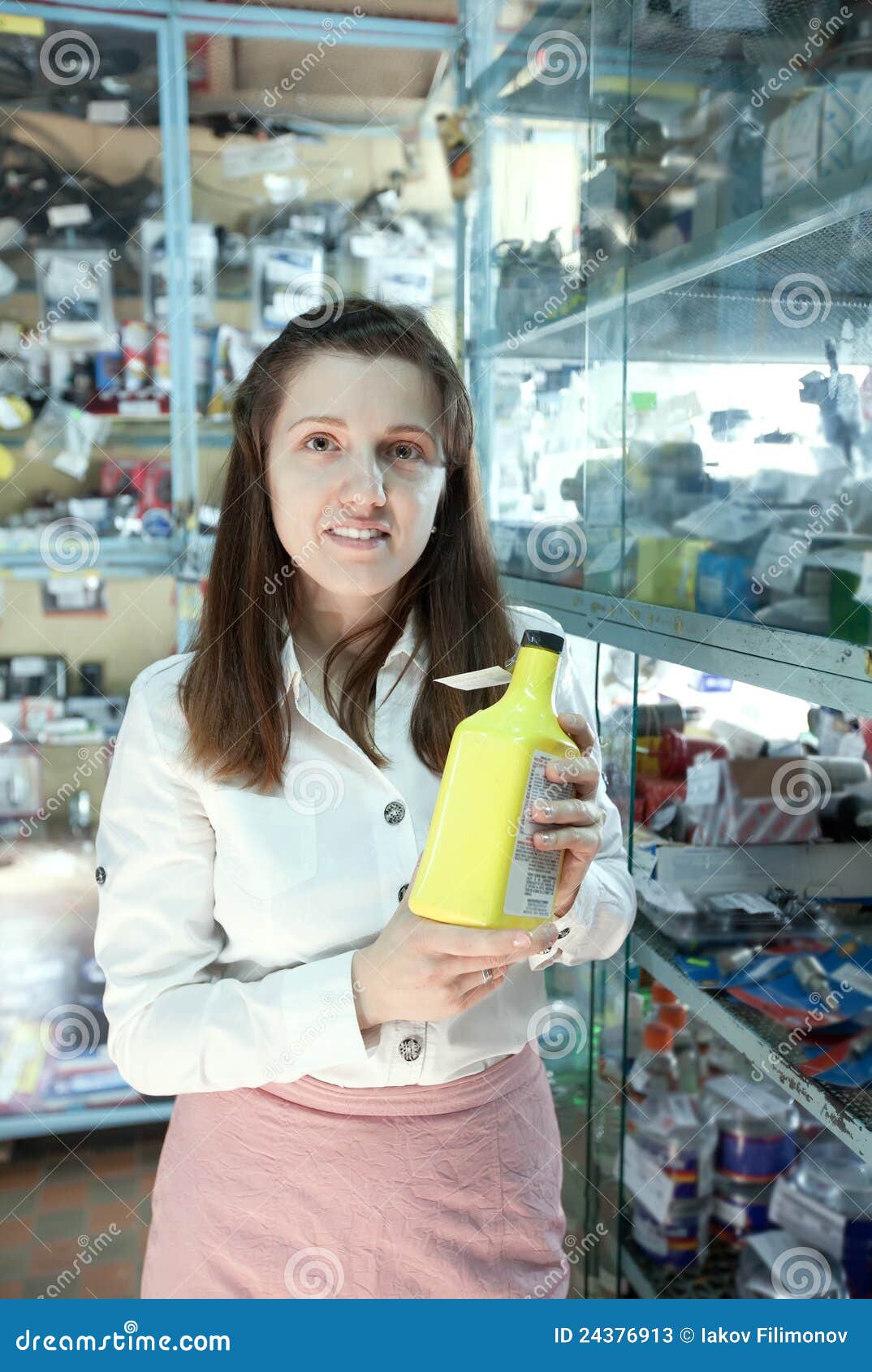 Woman chooses engine oil stock image. Image of counter - 24376913